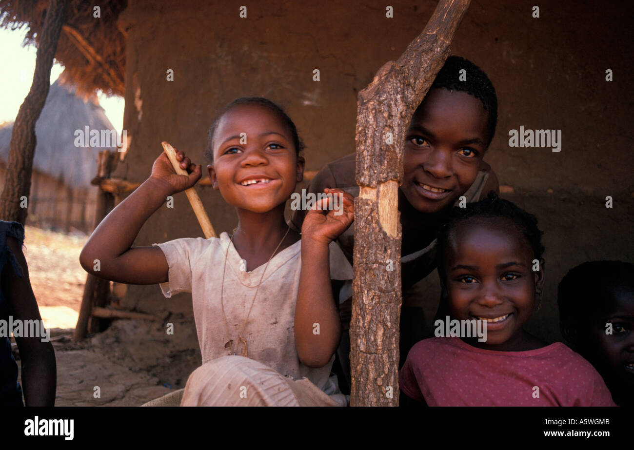 Four happy Shona children outside a mud hut in Mashonaland, Northern ...