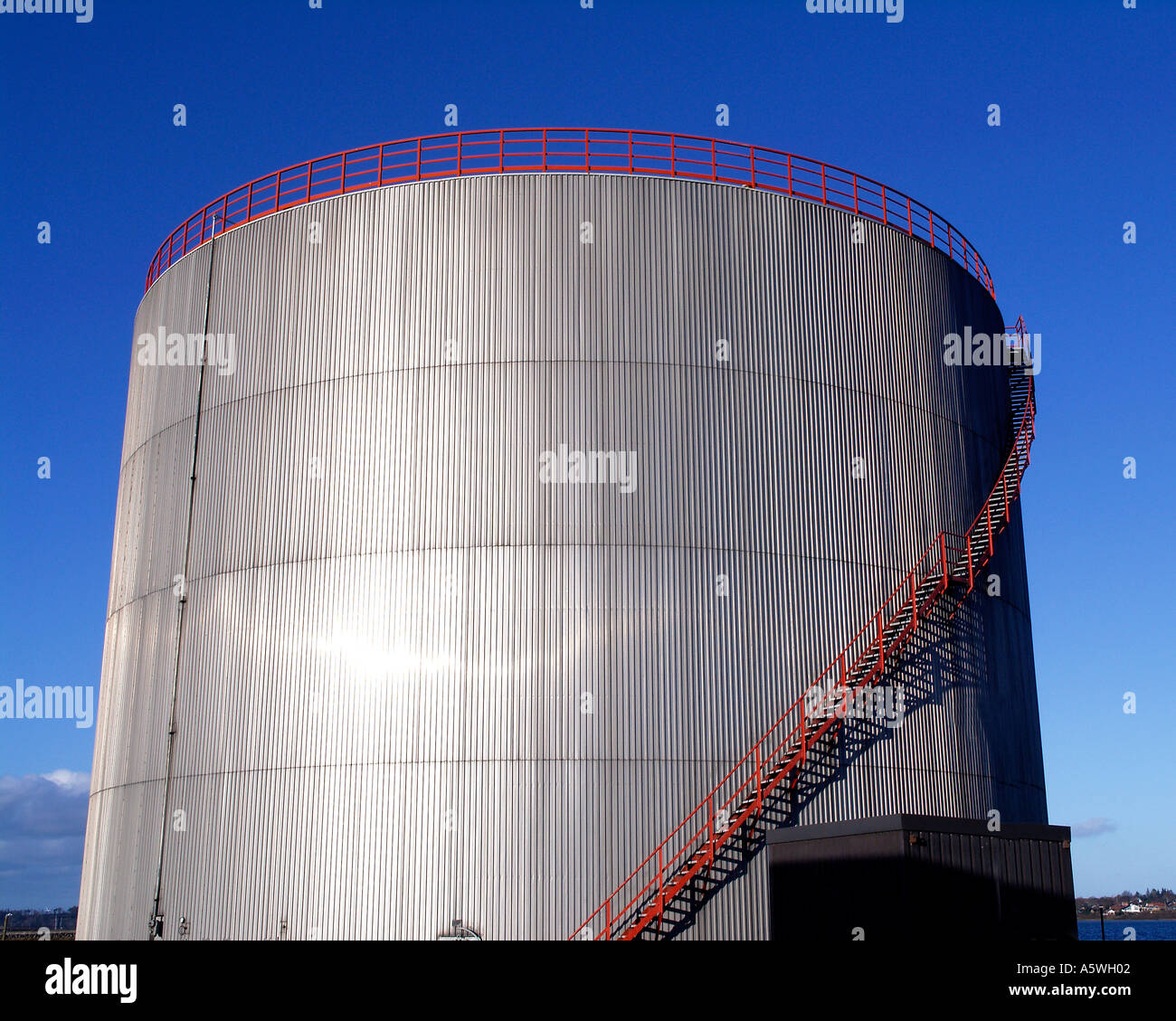 Gasoline Oil fuel storage tank with red stairs Stock Photo - Alamy