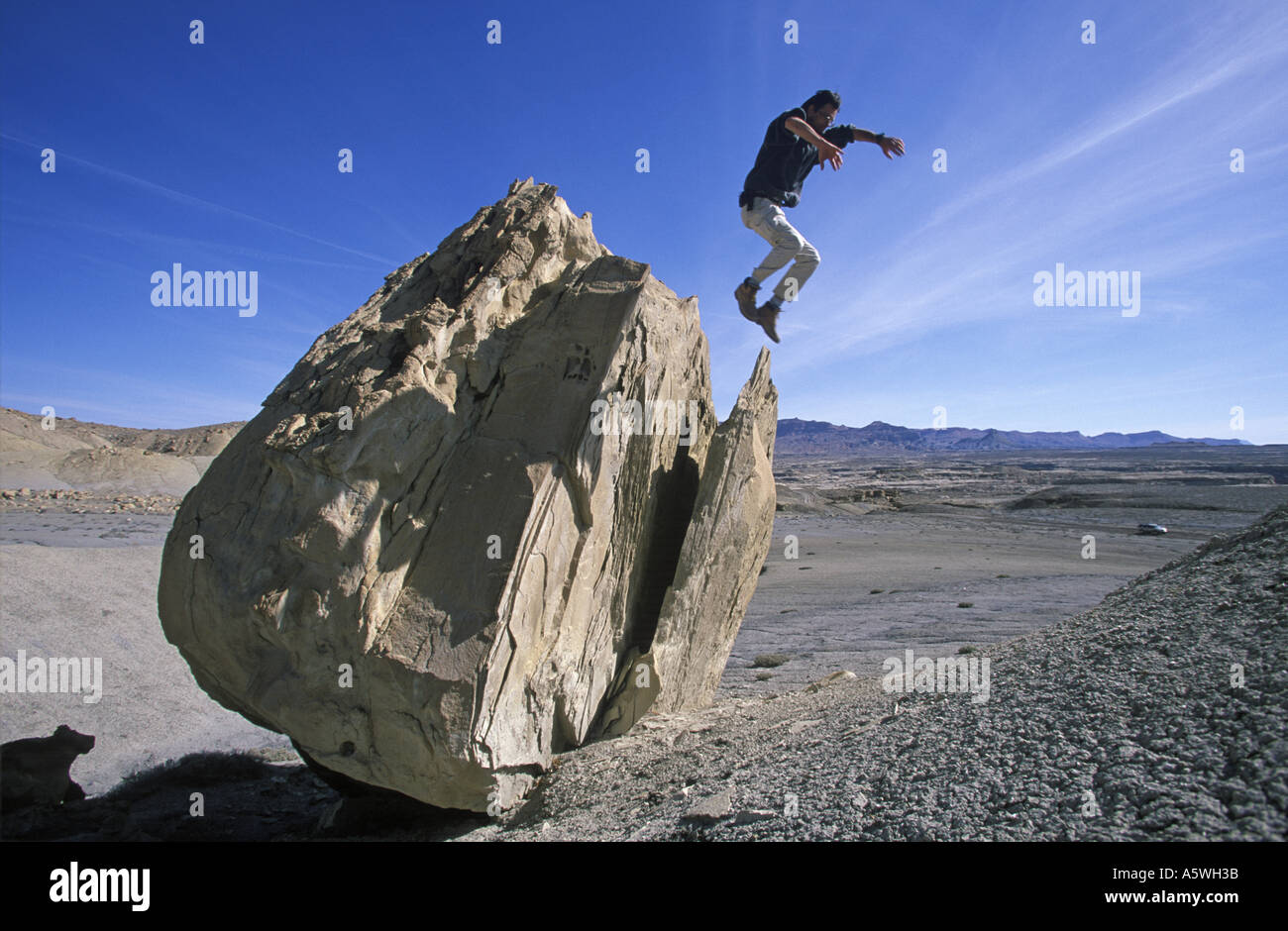 man jumping from a rock Glen Canyon National Recreation Area Utah USA ...