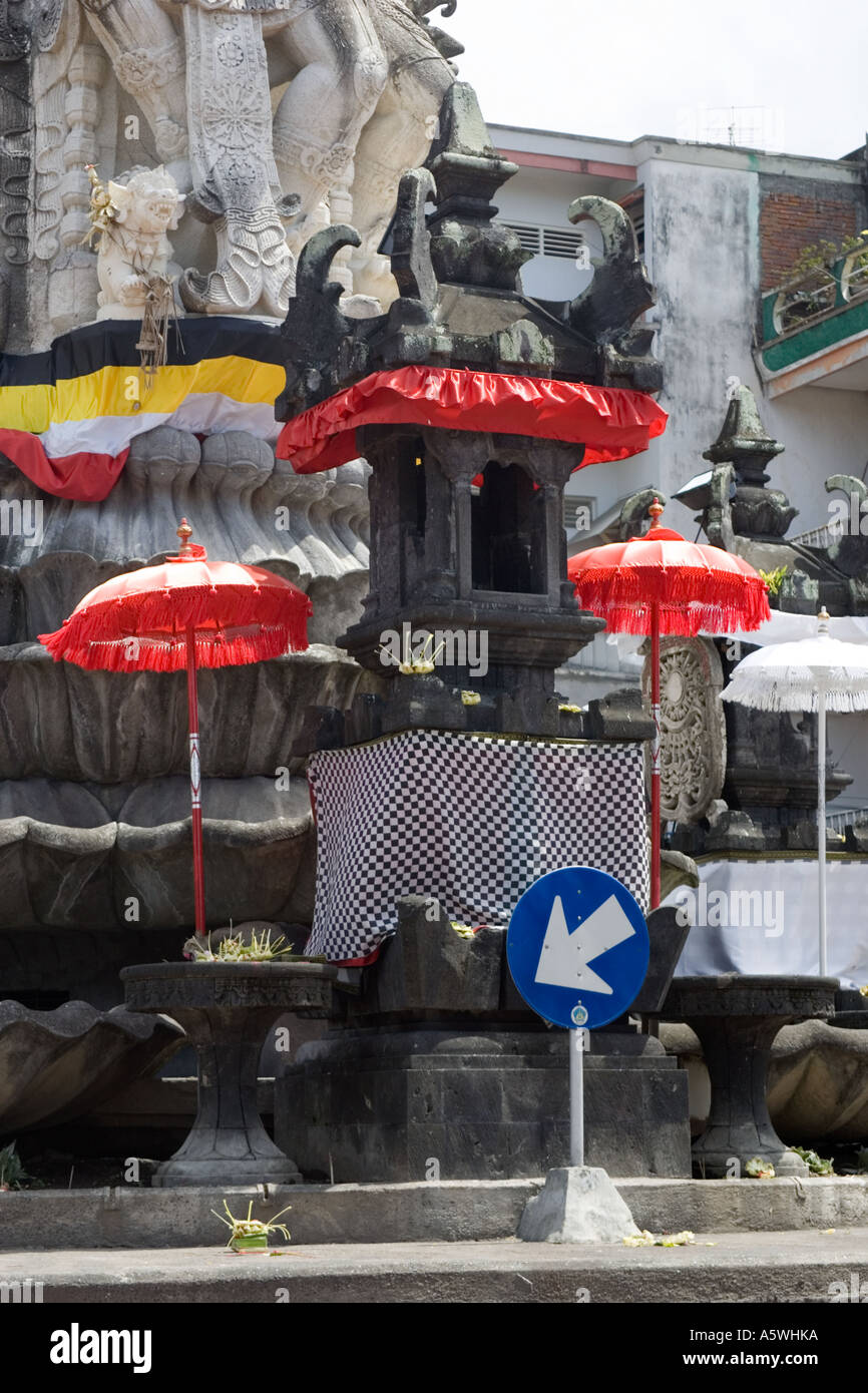 Shrine at base of statue on roundabout Semarapura Klungkung Bali ...
