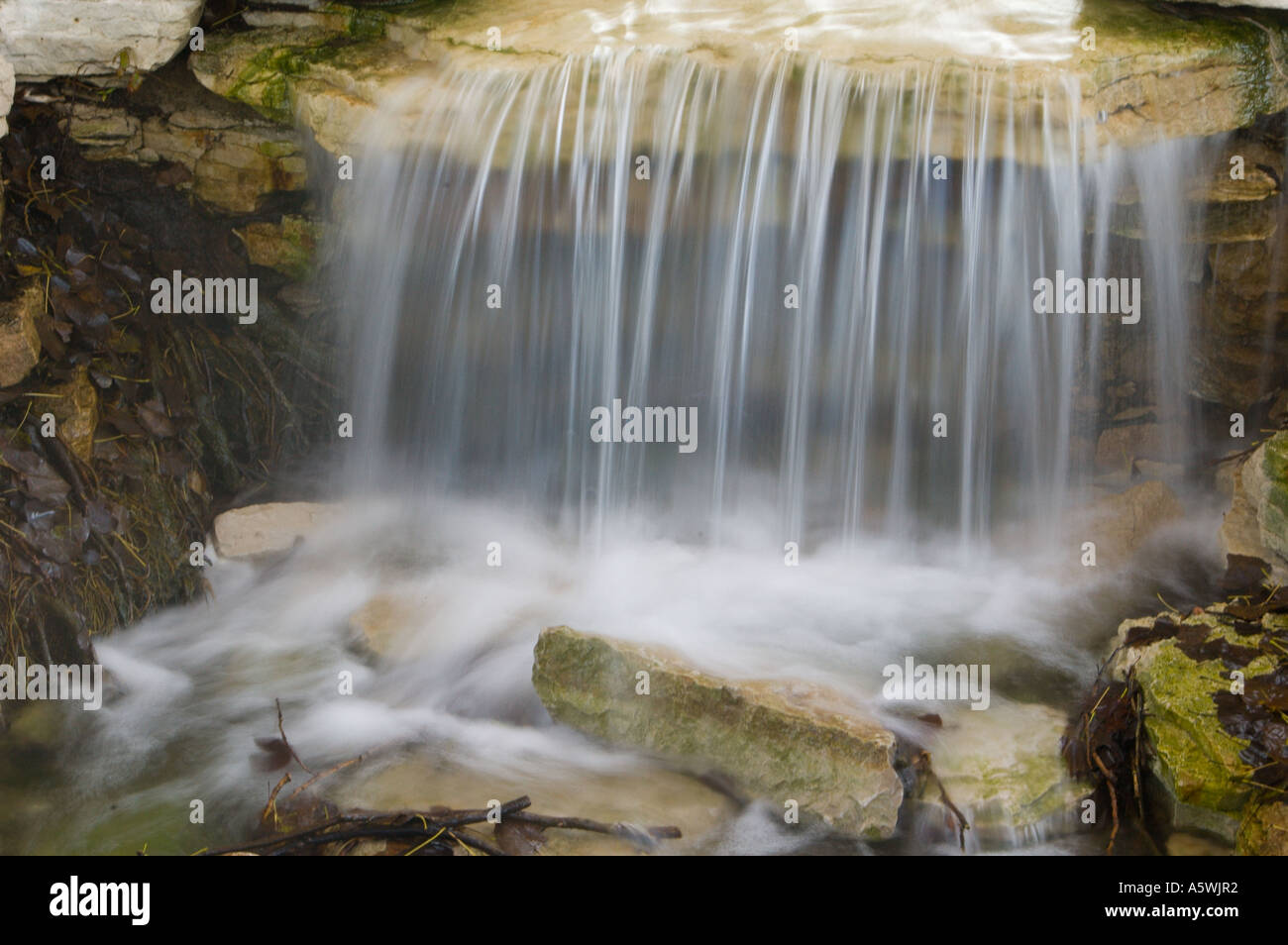 Streaming water, park waterfall Stock Photo - Alamy