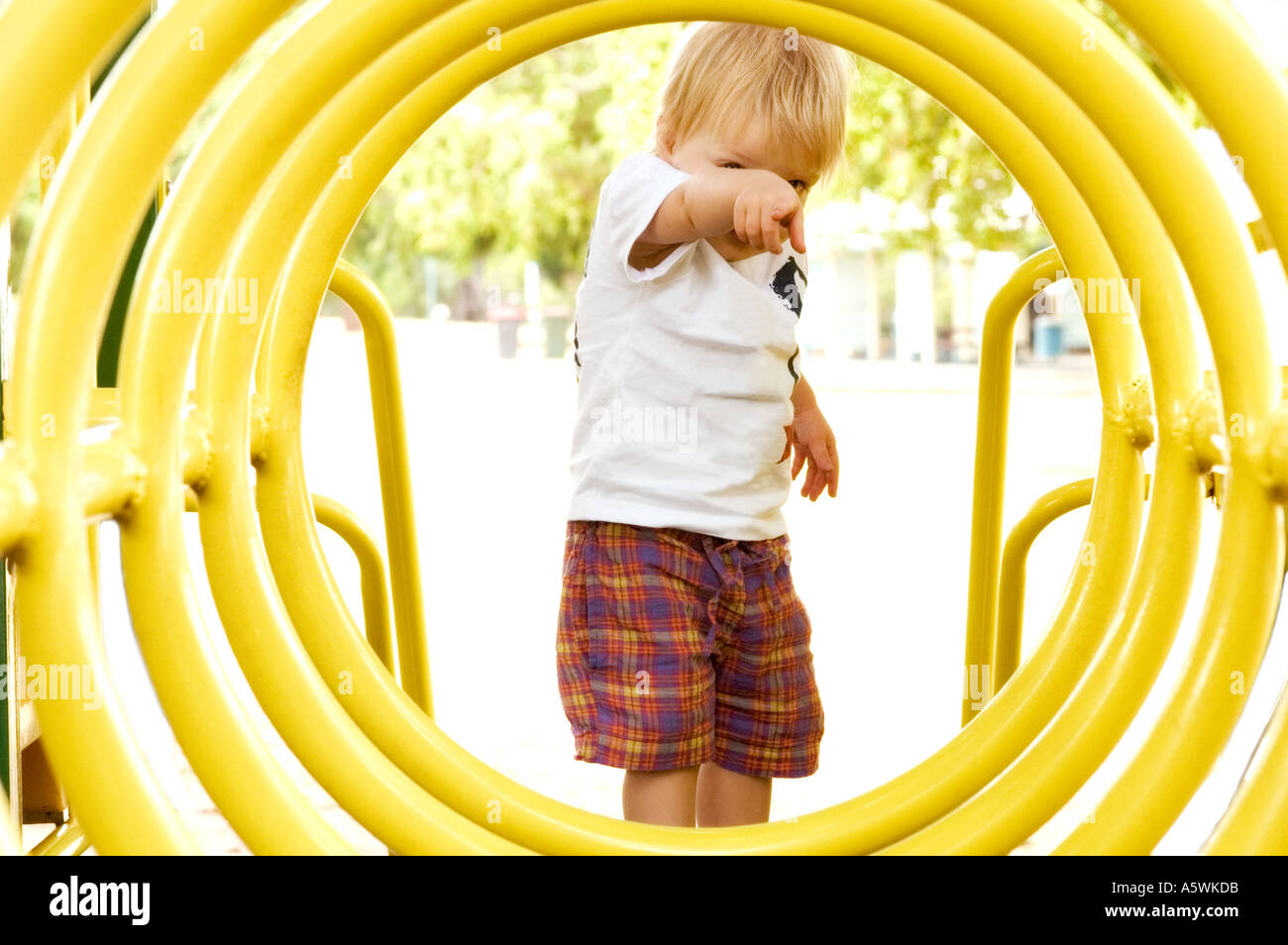 Toddler pointing in playground tunnel Stock Photo - Alamy