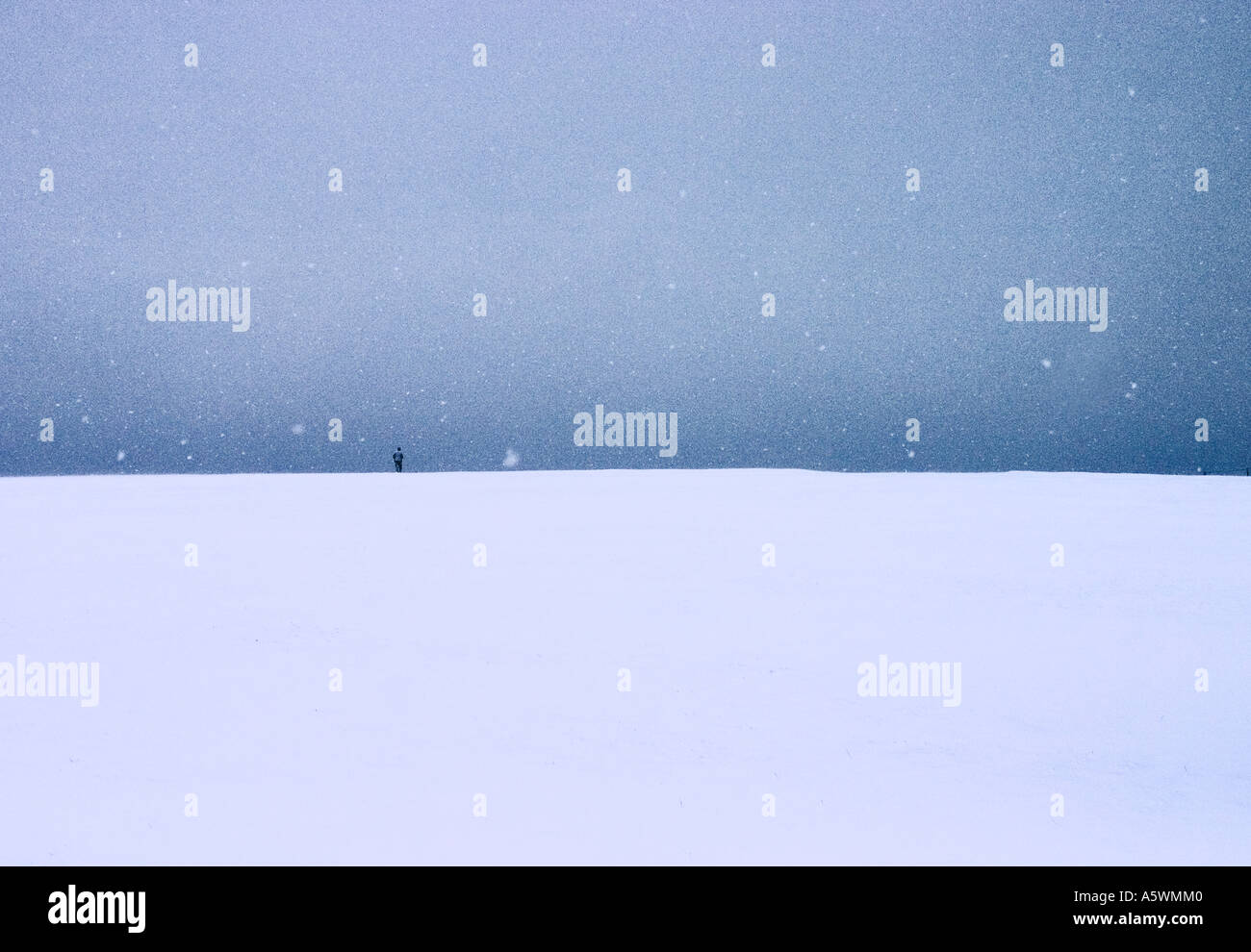 Snowy landscape with distant male figure walking into the void Stock ...