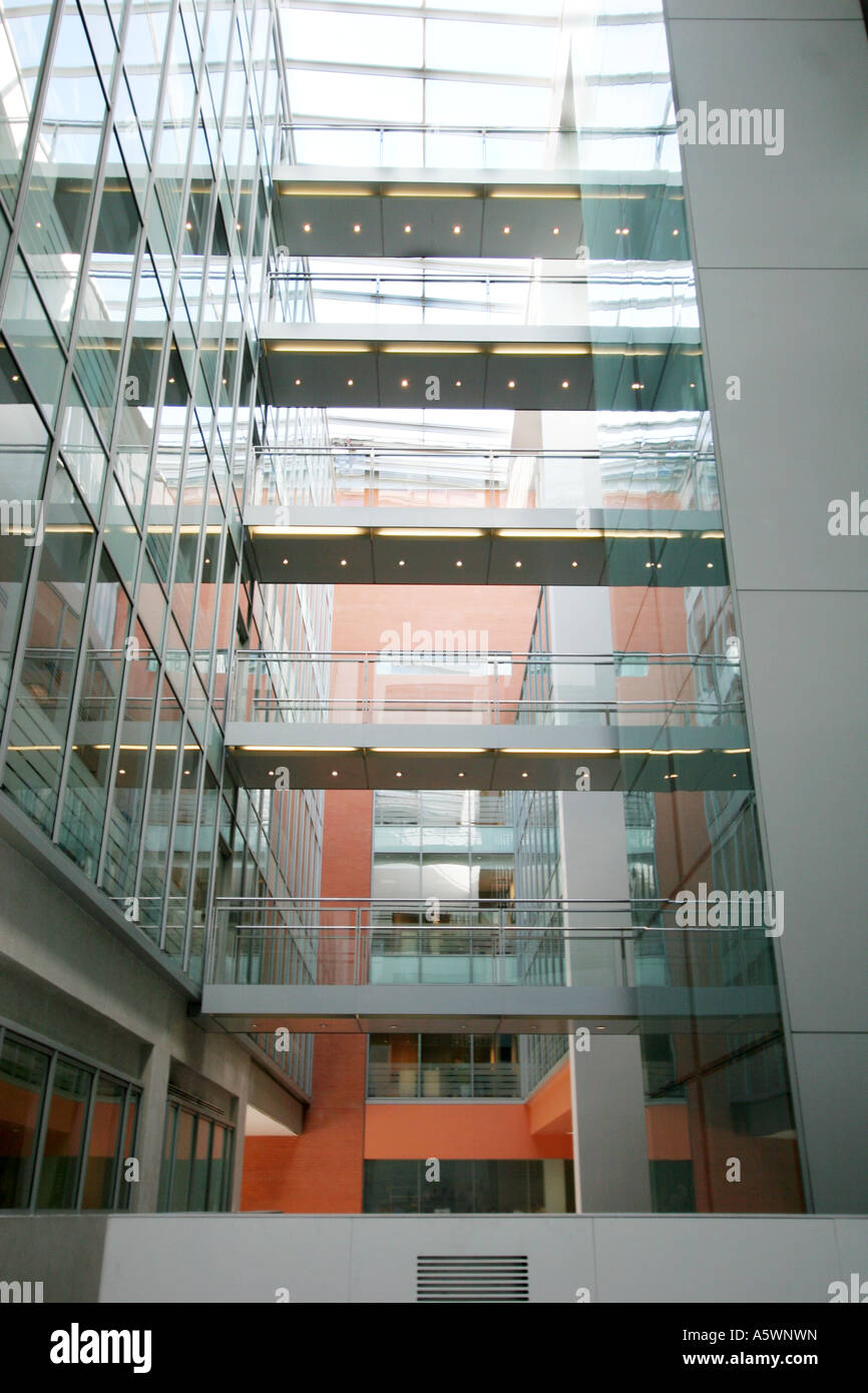 Modern glass and steel office interior with balconies and walkways ...