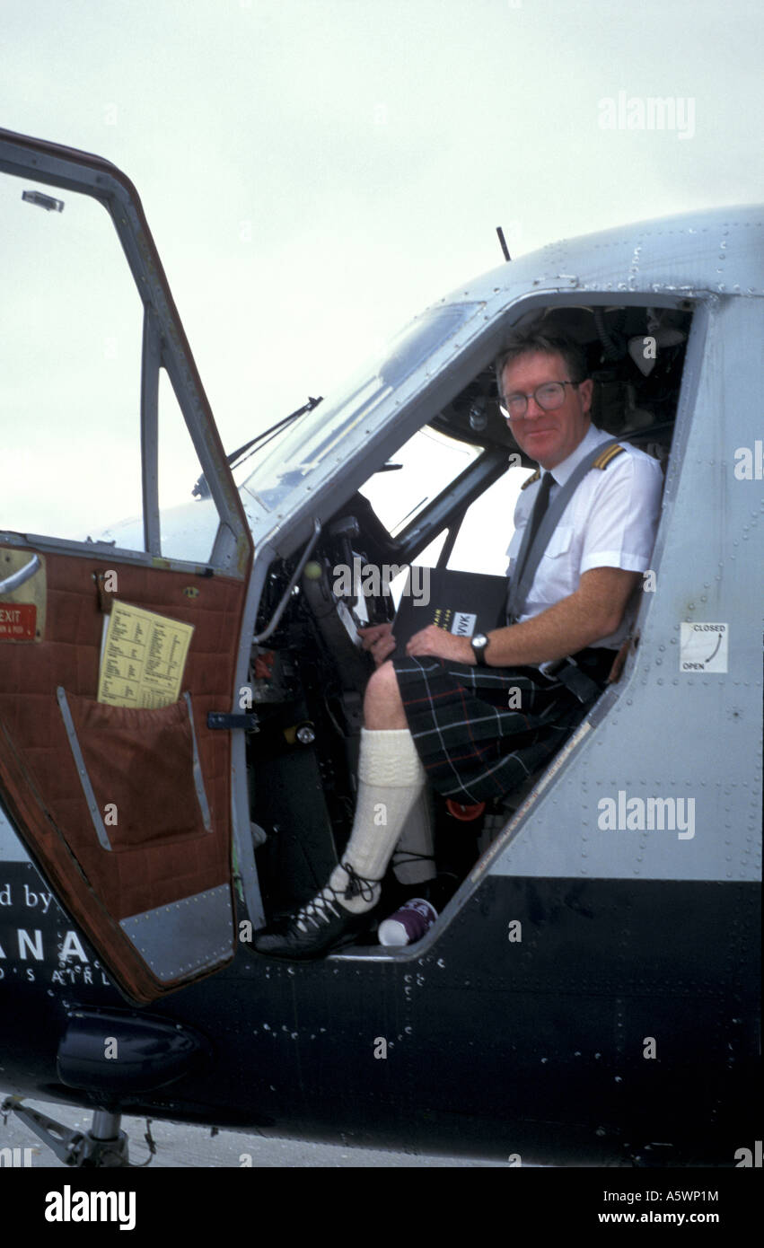 Pilot in a kilt on plane on the beach at Barra Airport in the outter ...