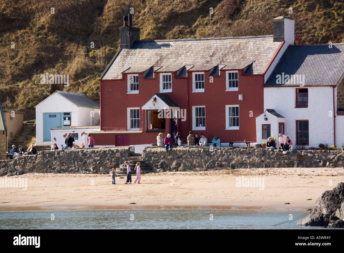 Ty Coch Inn red pub on a beach at Porth Dinllaen village in bay on ...