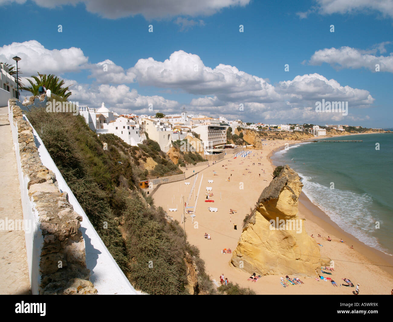 PRAIA DO PENCO and sandstone cliff with tourists on beach with white ...