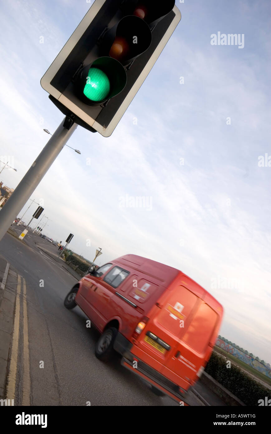 Red Post office van passing a green traffic light Stock Photo - Alamy