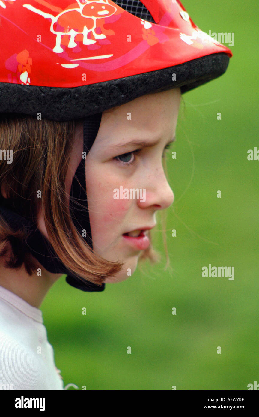 young girl wearing a red cycling safety helmet Stock Photo - Alamy