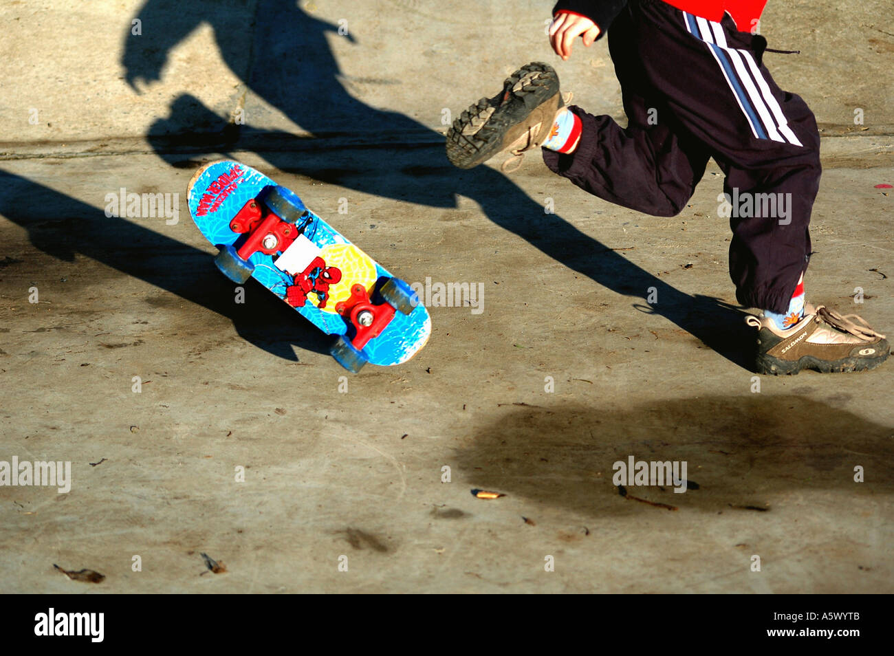 young boy doing jumps on a skateboard Stock Photo - Alamy