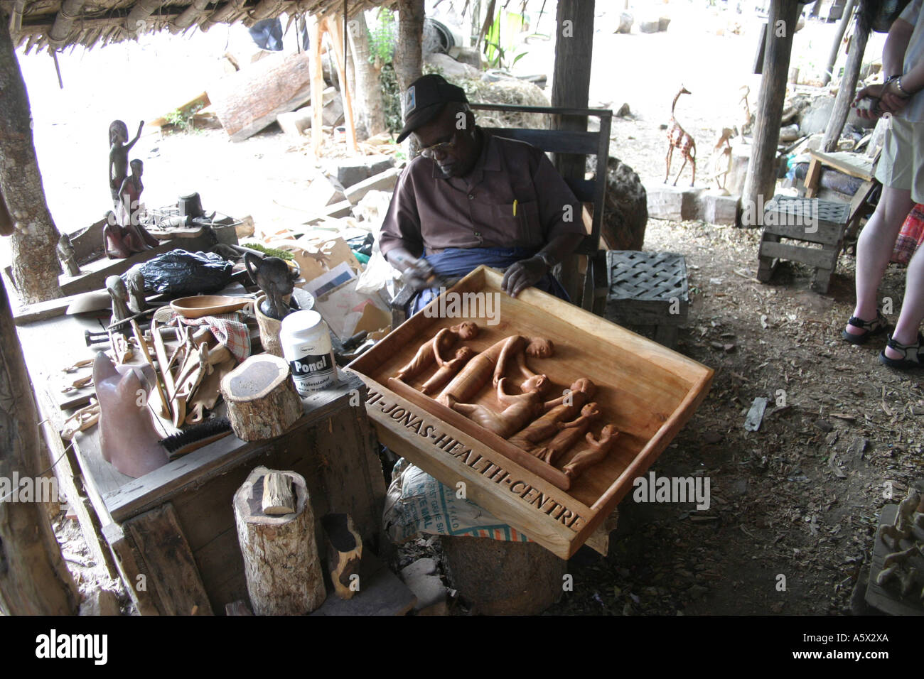 A woodcarver at the Akamba Workshops in Mombasa, Kenya Stock Photo - Alamy