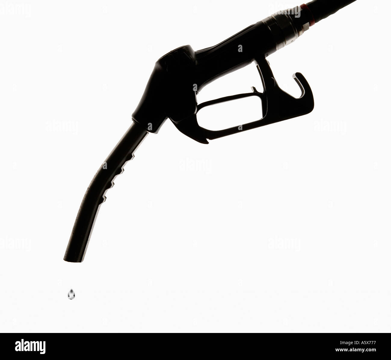 PETROL PUMP IN SILHOUETTE WITH SINGLE DROP OF FUEL FALLING FROM NOZZLE ...