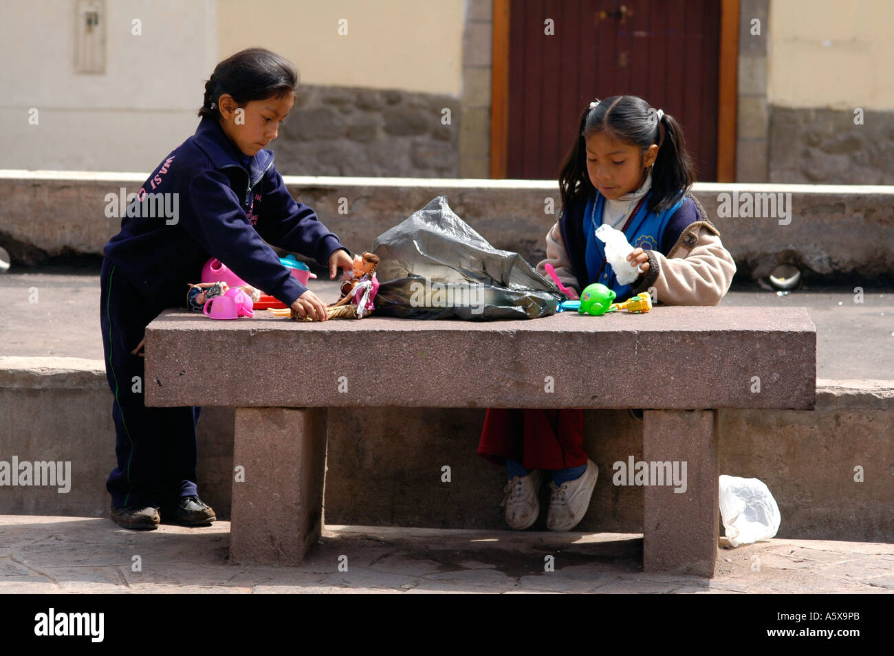 Peruvian girls playing with toys, Cusco, Peru, South America Stock ...