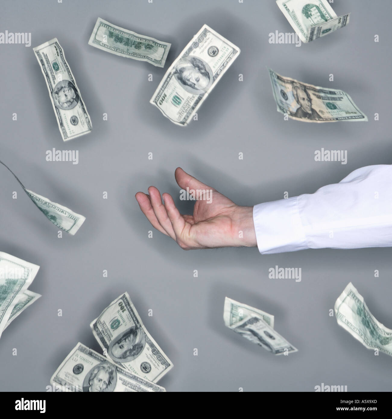 Hand reaching out to catch falling money Stock Photo - Alamy