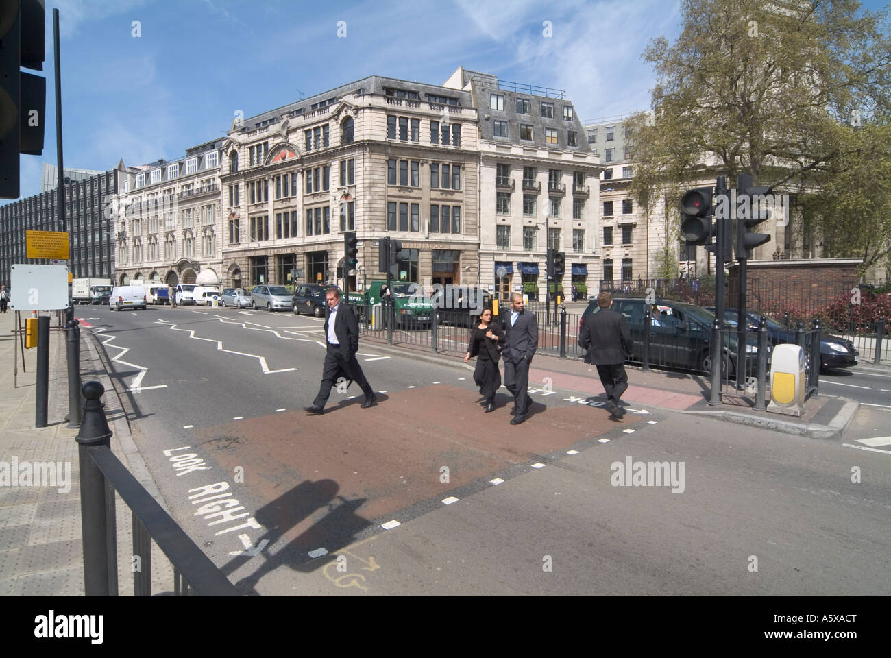 pedestrians crossing the road at a pedestrian crossing in london city ...