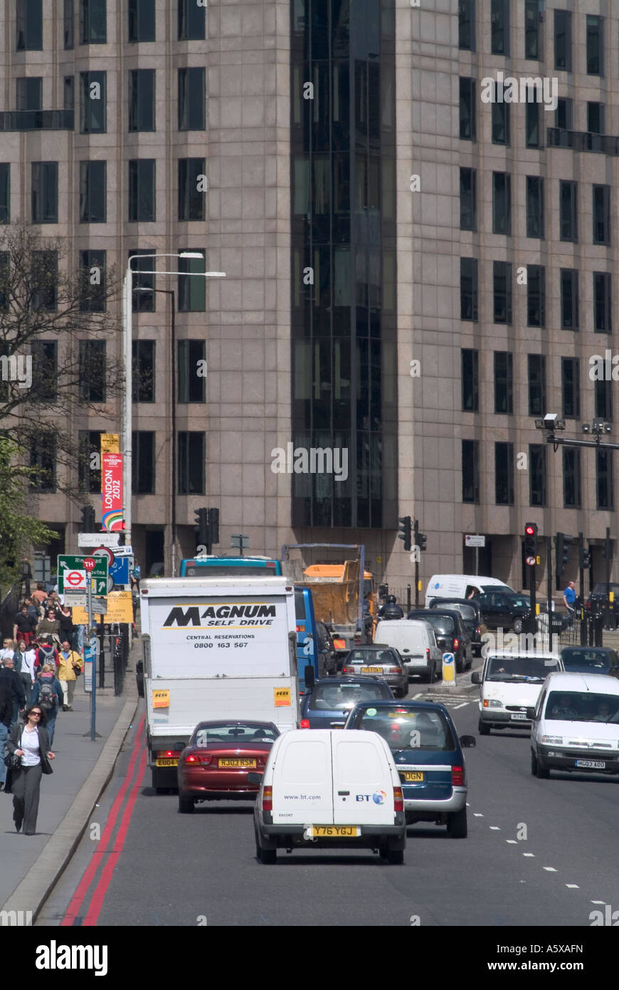 Busy traffic travelling along a red route road in london city centre ...