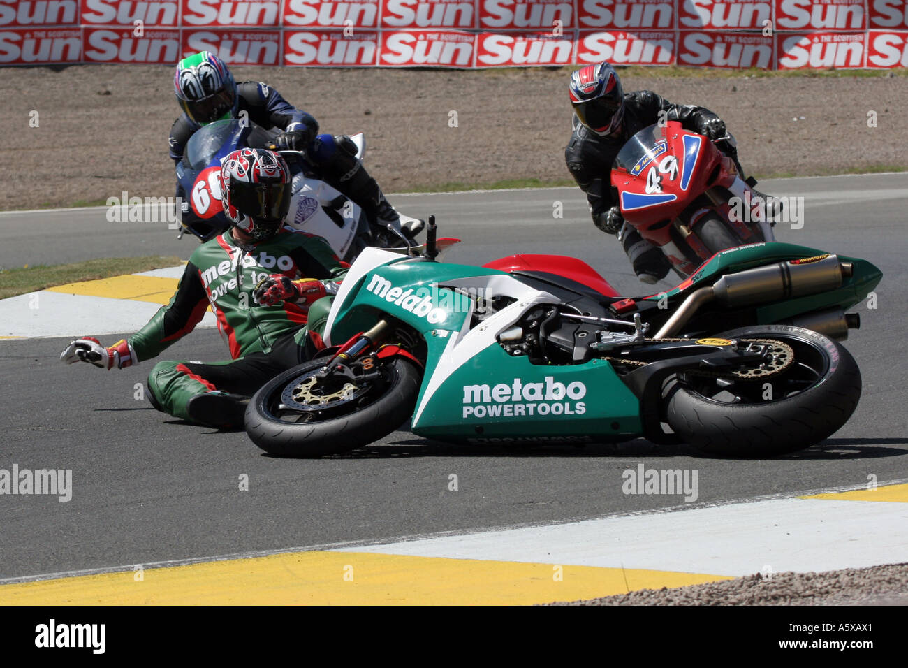 Motorcycle racer falling at sharp corner in danger from approaching ...
