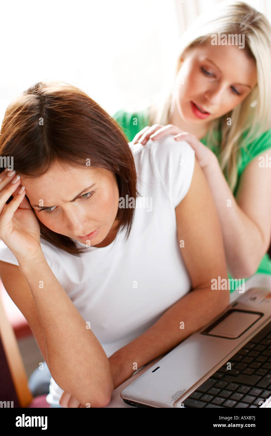 Two women consoling Stock Photo - Alamy