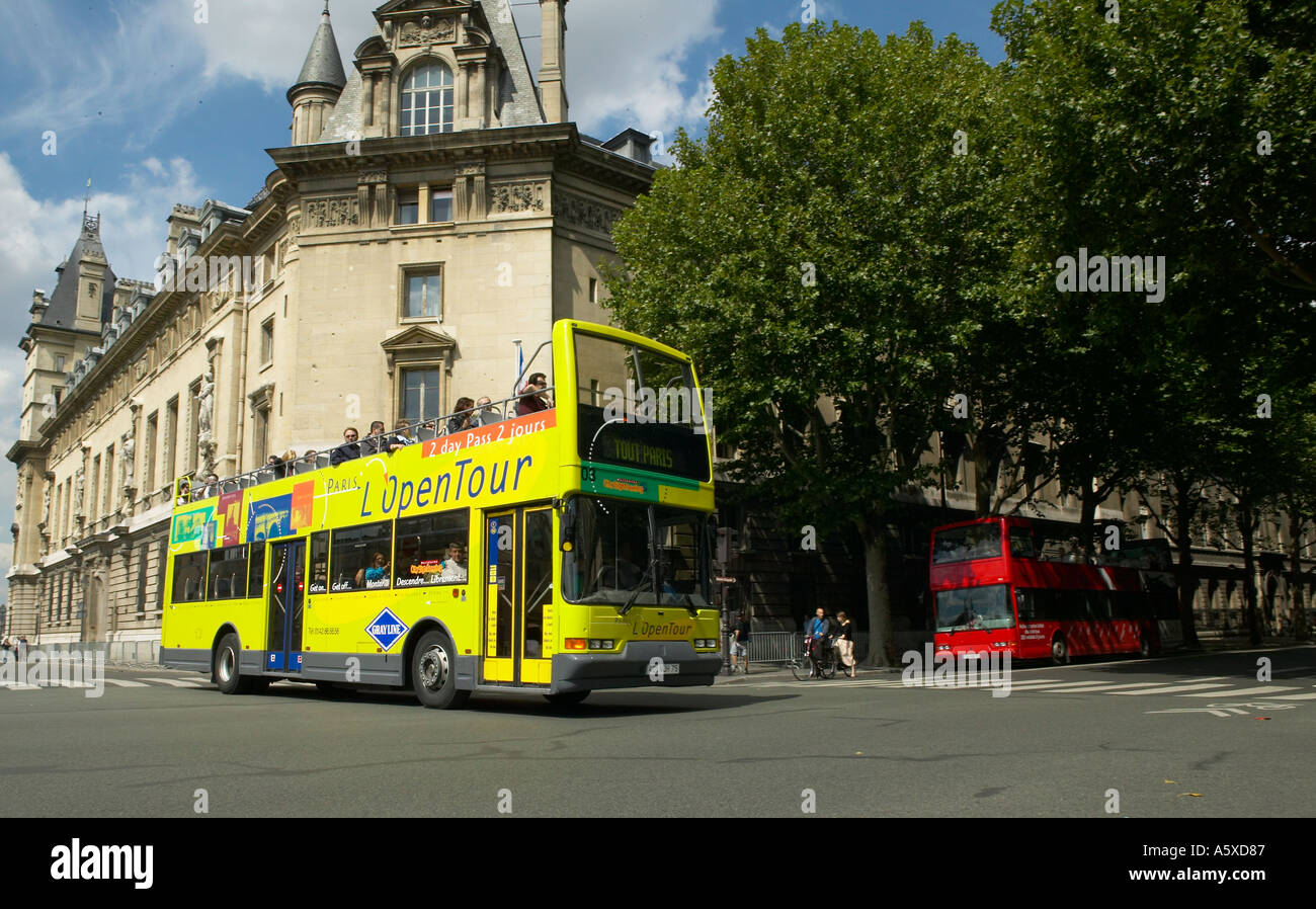 A red and a yellow double decker bus take tourists around the Paris ...