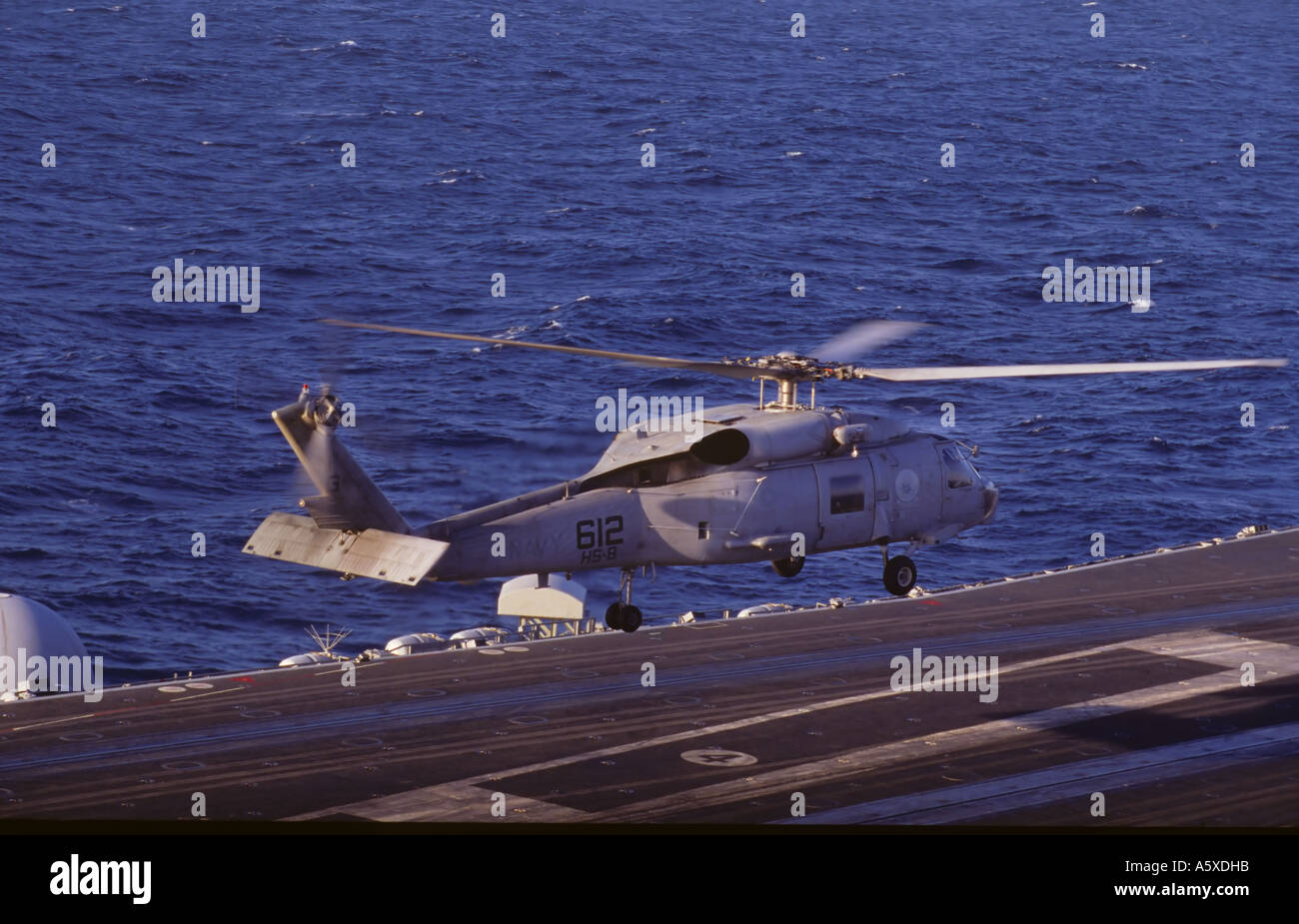 helicopter landing on deck of aircraft carrier Stock Photo - Alamy