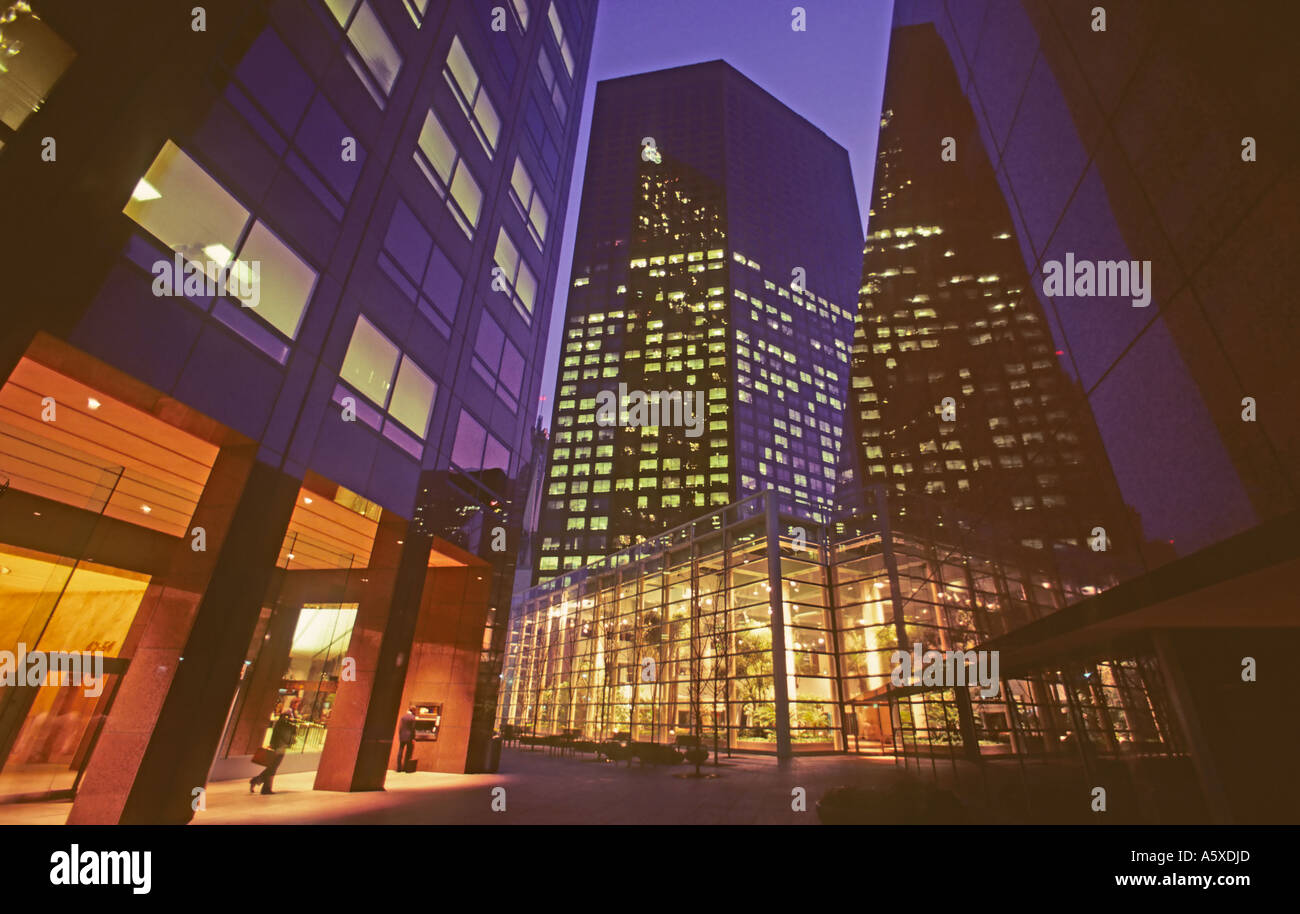 street level evening view of skyscrapers in downtown business district ...
