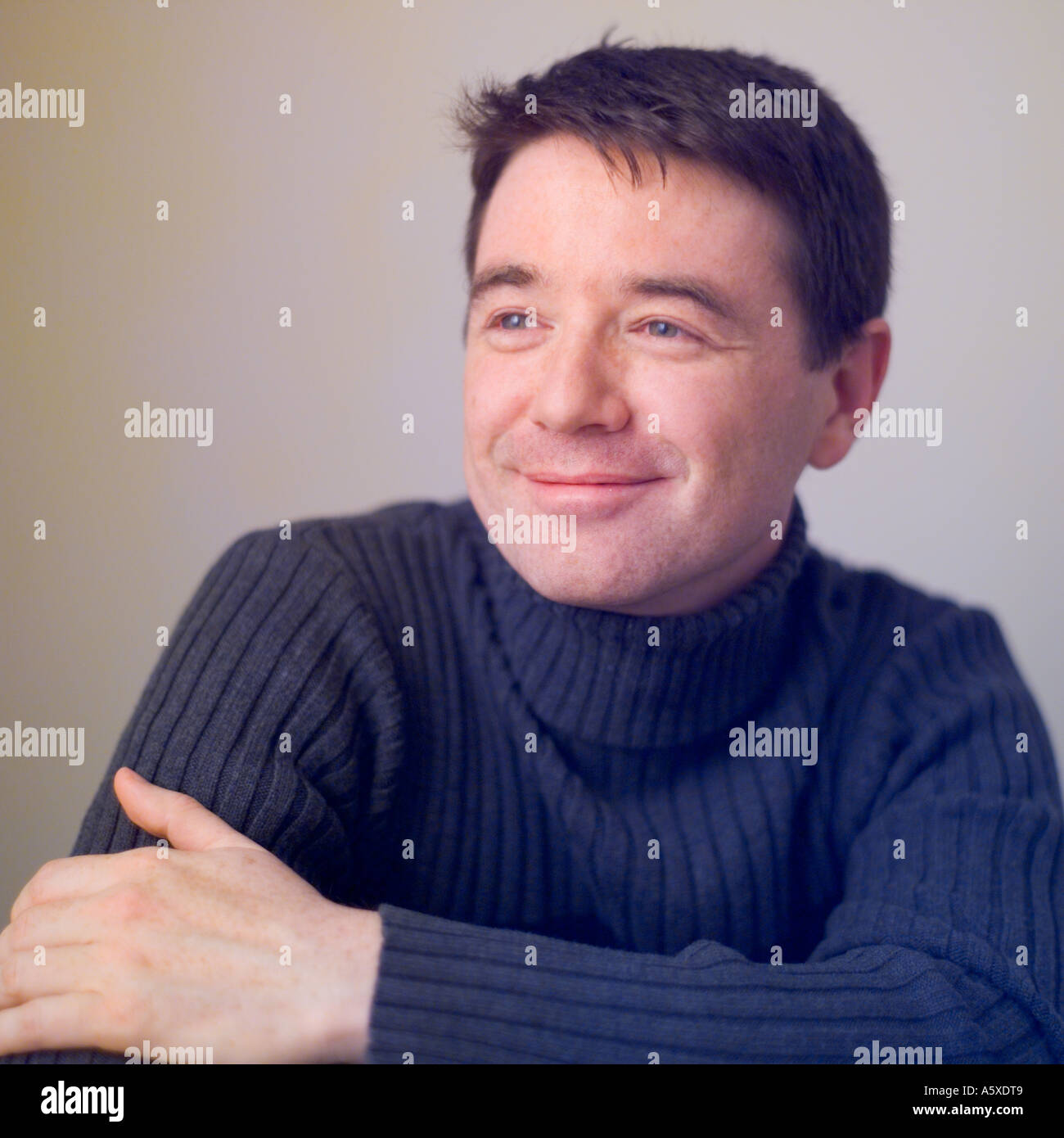 Man Smiles While Looking Off Camera Stock Photo - Alamy