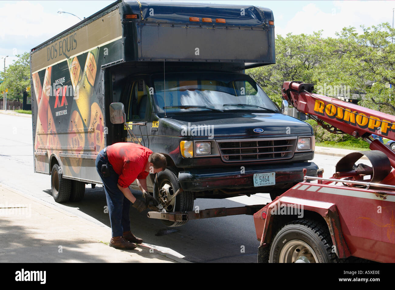 WISCONSIN Milwaukee Man attach chain to wheel of truck preparing ...