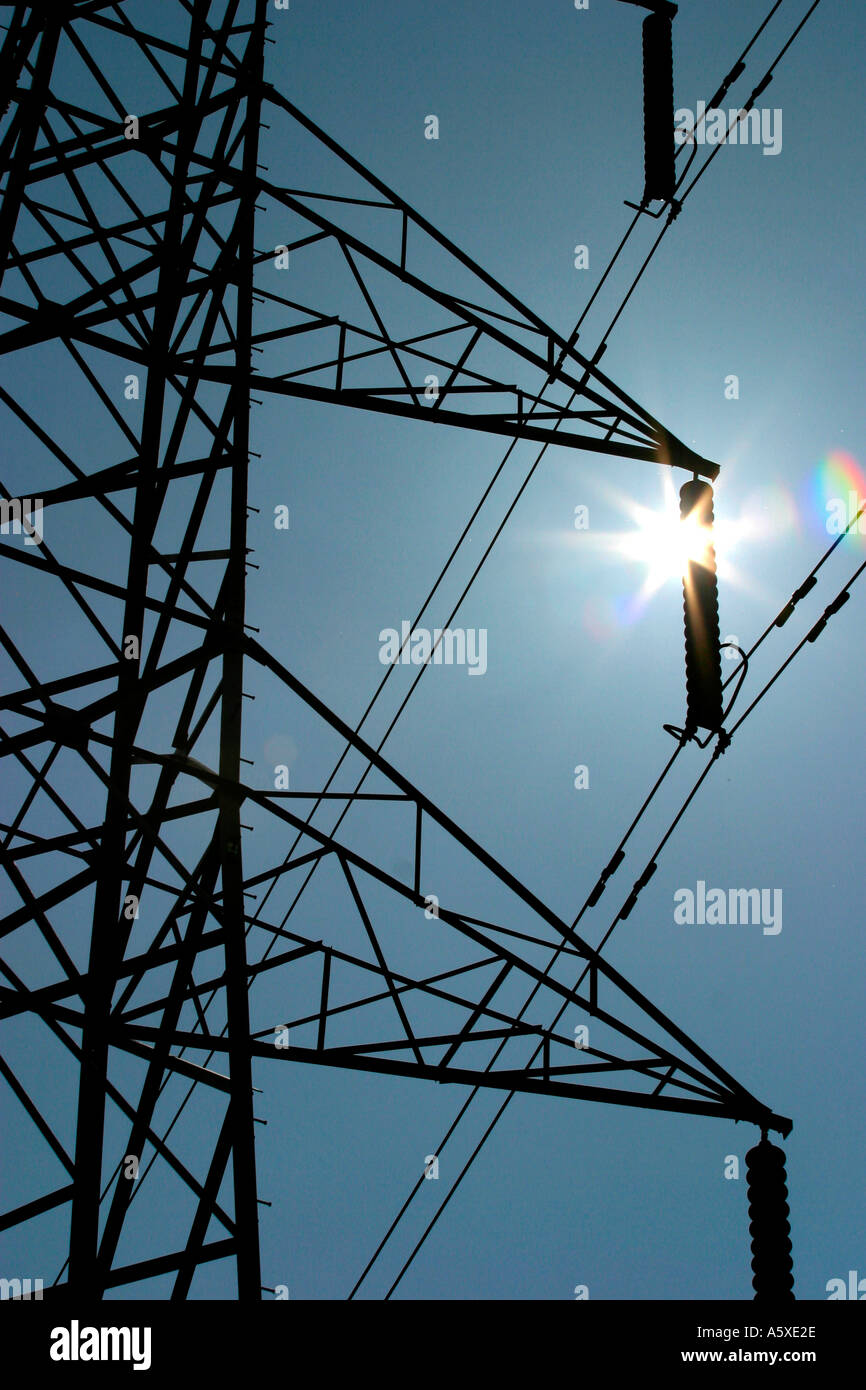 Sun shining through high tension electricity powerline pylon Stock ...