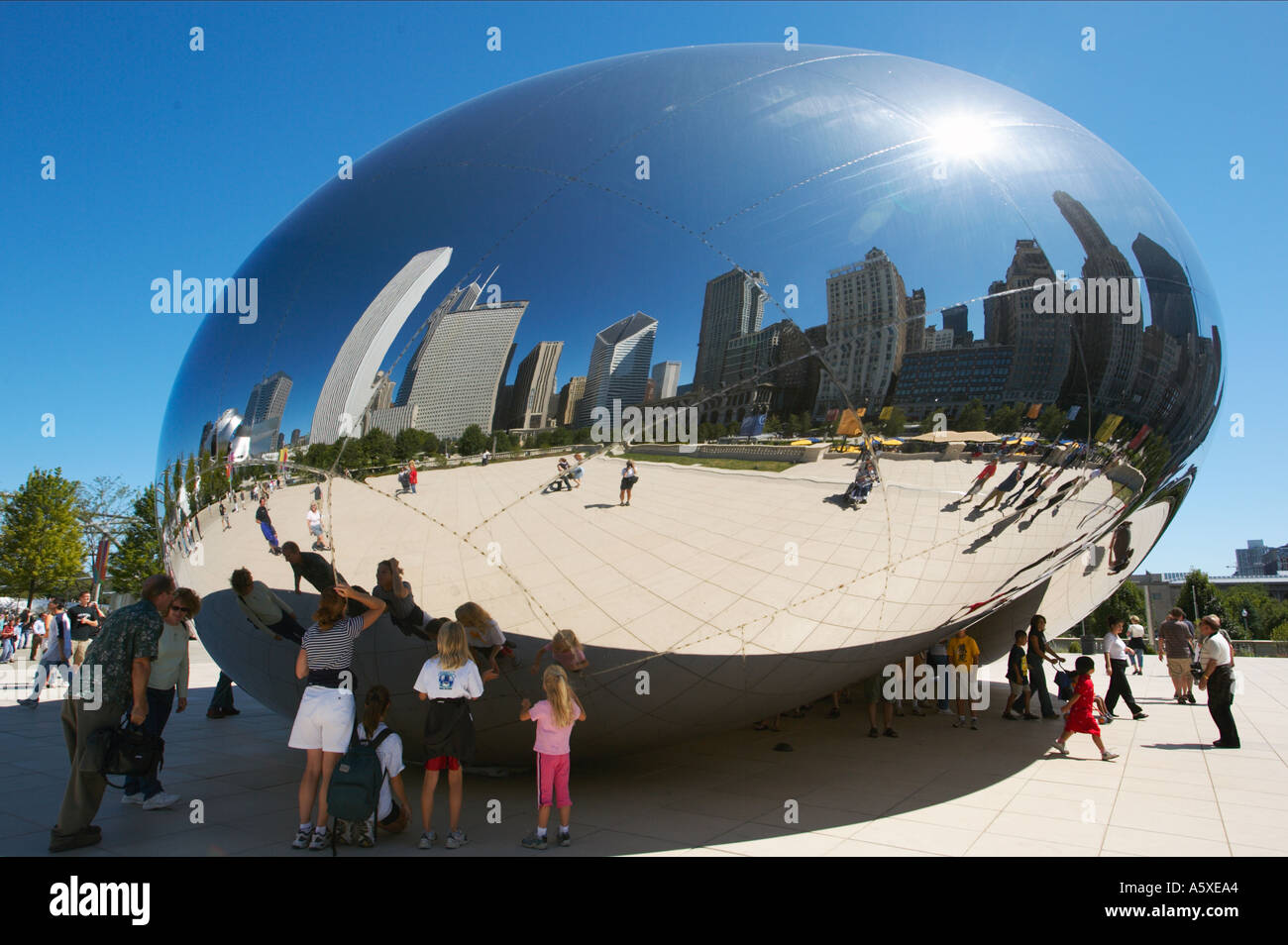 SCULPTURE Chicago Illinois People look at reflection in Cloud Gate ...
