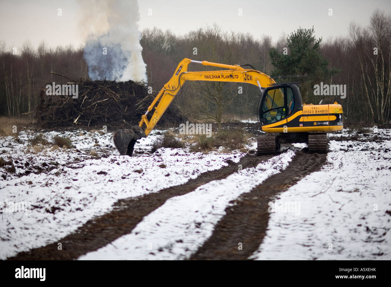 Digger in snow Stock Photo - Alamy