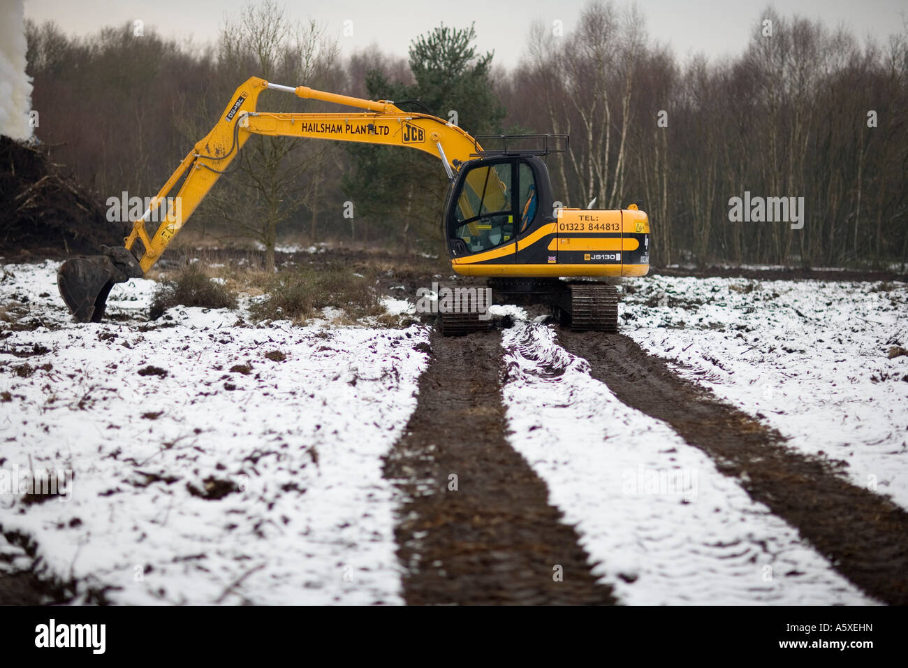 Digger in snow Stock Photo - Alamy