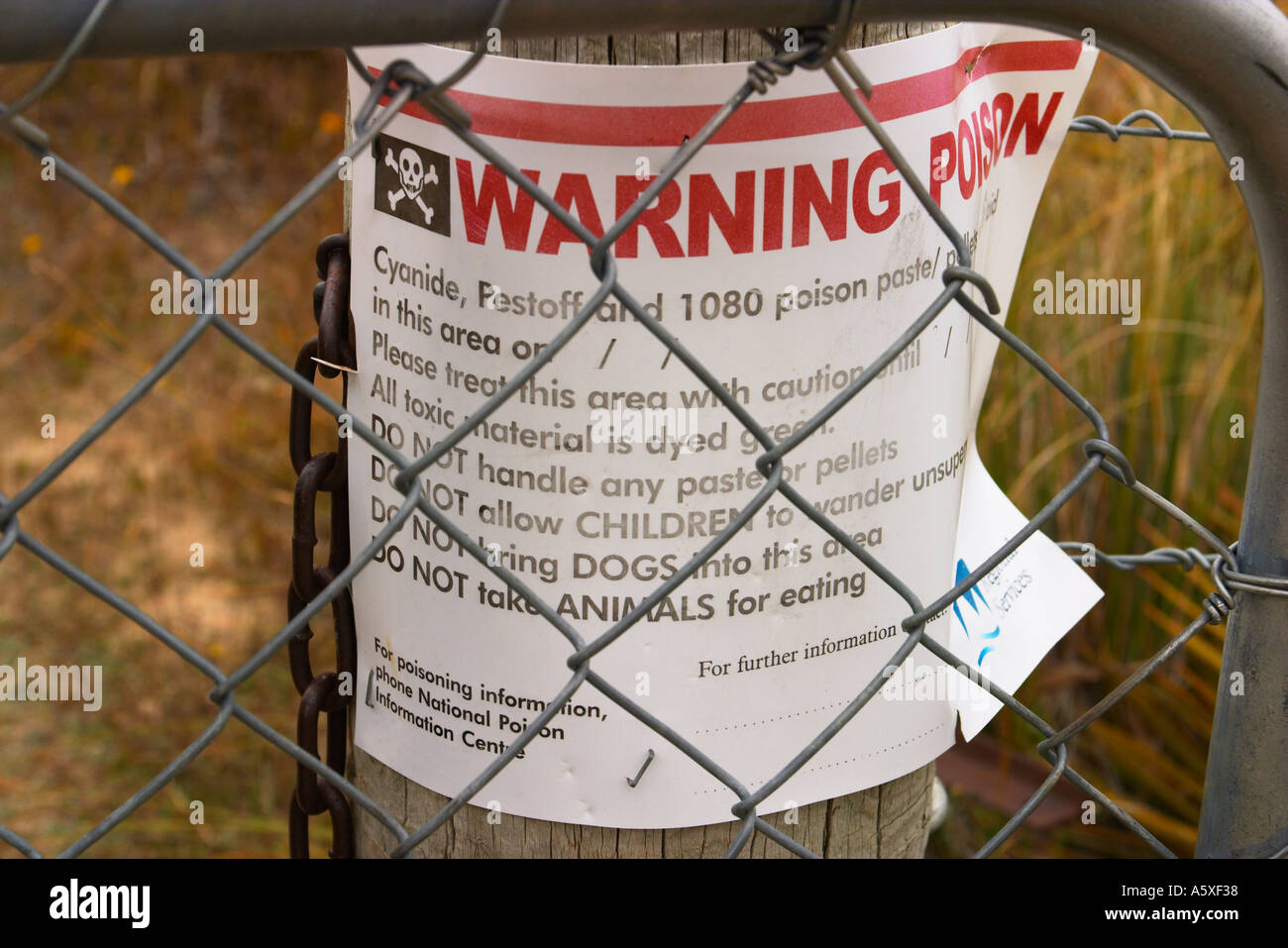NEW ZEALAND Cardrona Valley Poison warning sign on fence post behind ...