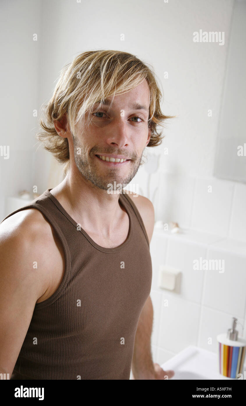 Young man standing near bathroom sink close up portrait Stock Photo - Alamy