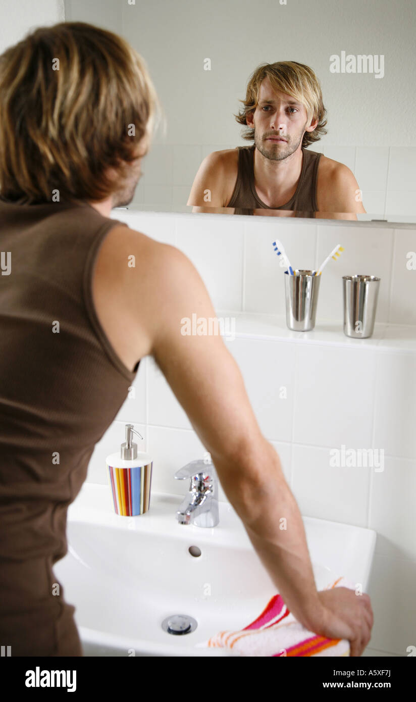 Young man leaning over sink hi-res stock photography and images - Alamy