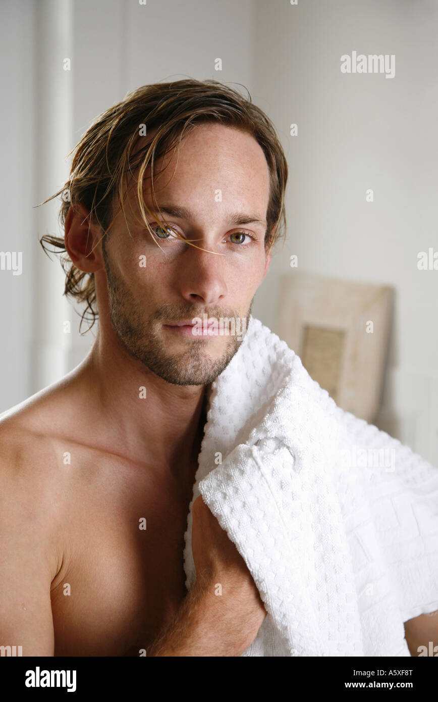 Young man drying his body with towel close up portrait Stock Photo - Alamy