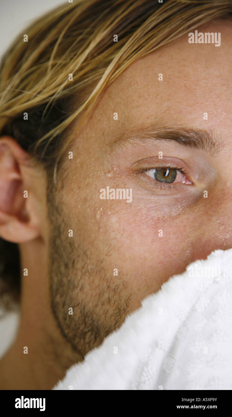 Young man drying his face with a towel close up portrait Stock Photo ...