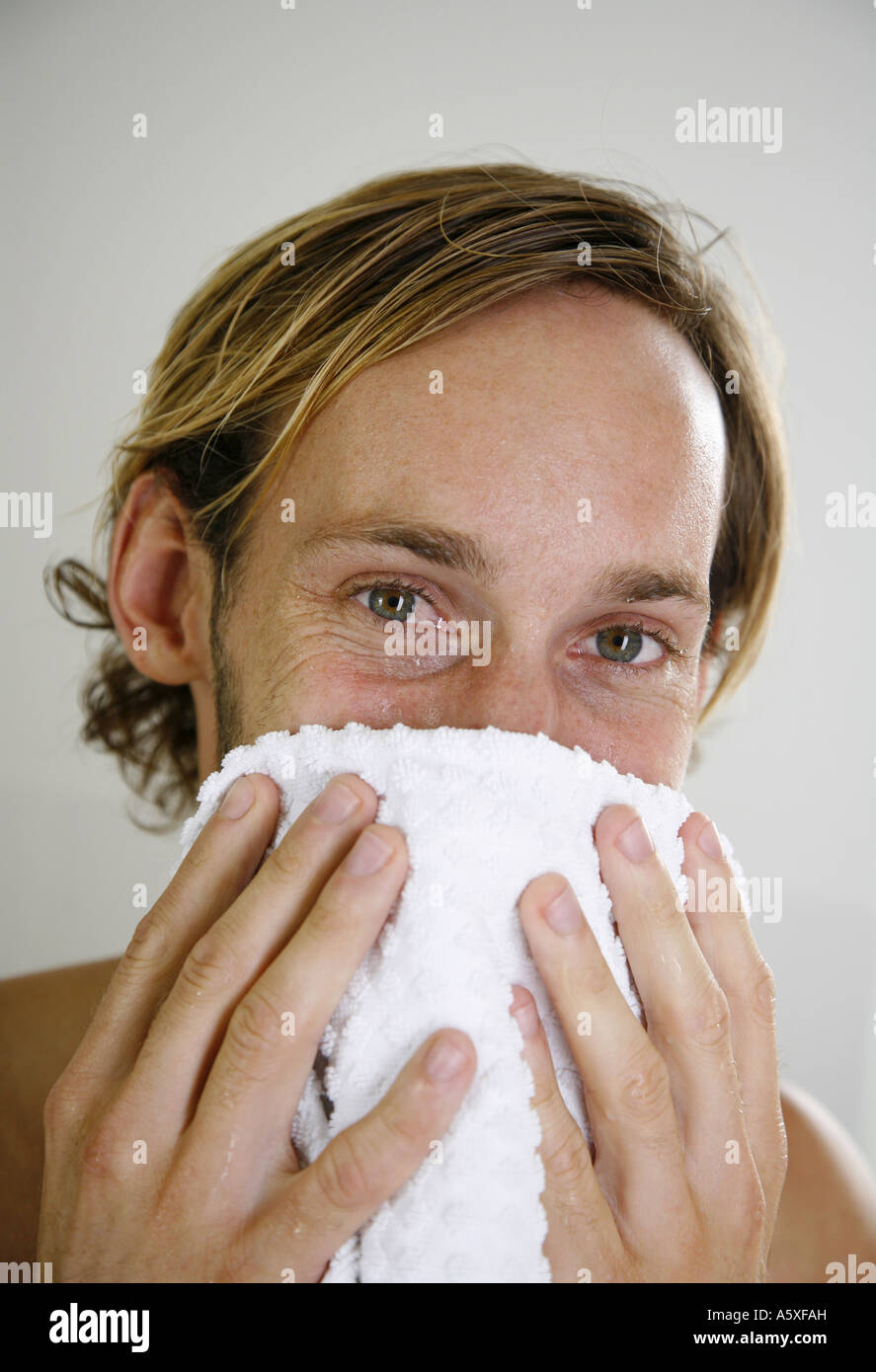 Young man drying his face with a towel close up portrait Stock Photo ...