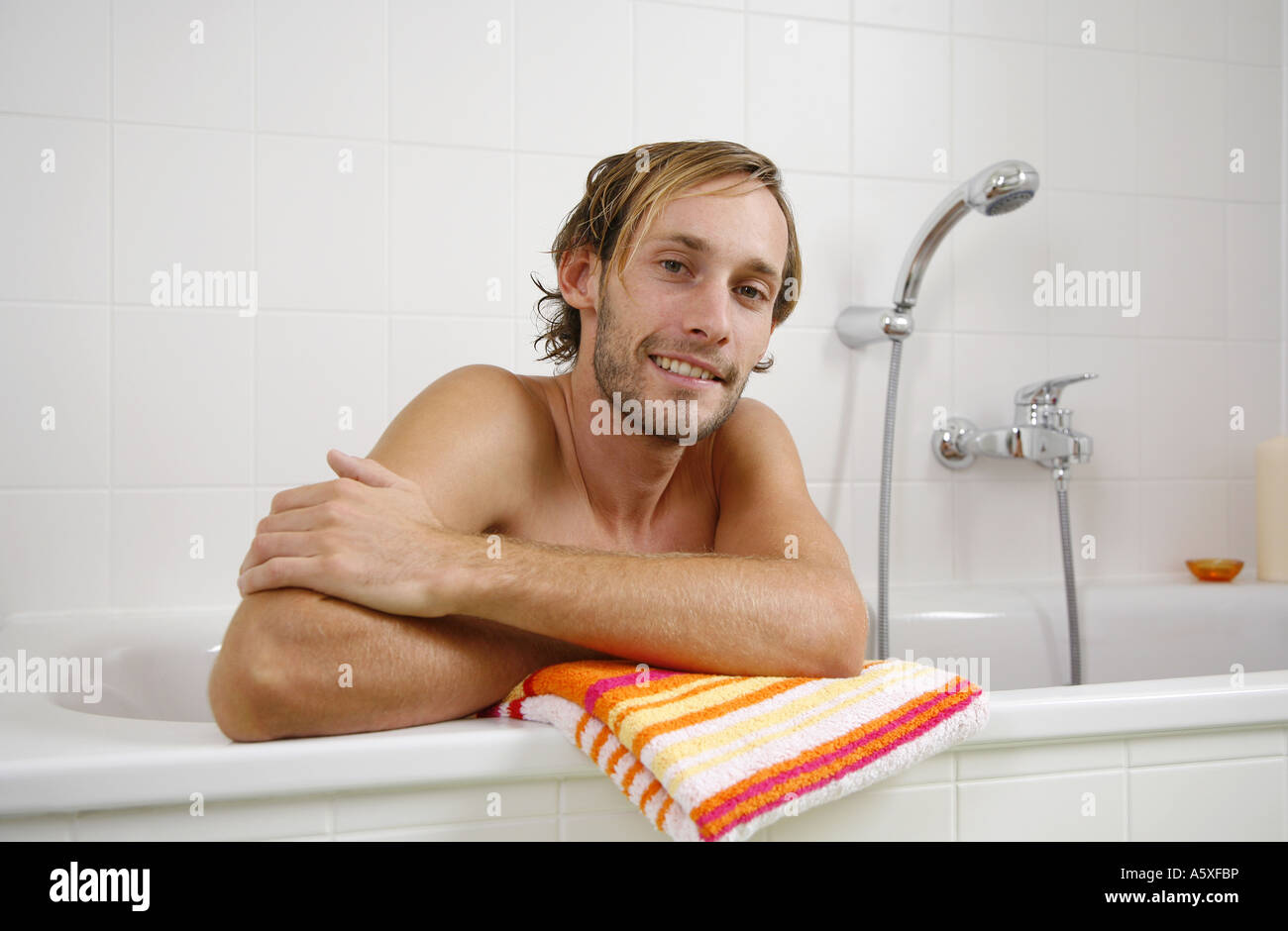Young man in bath tub close up portrait Stock Photo - Alamy