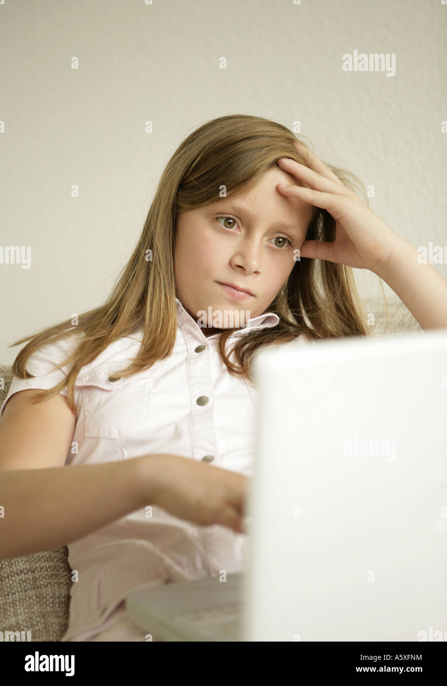 Girl sitting on sofa and using laptop angry close up Stock Photo - Alamy