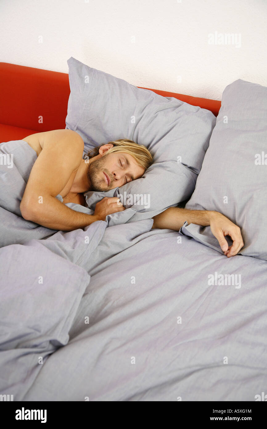 Young man sleeping high angle view Stock Photo - Alamy