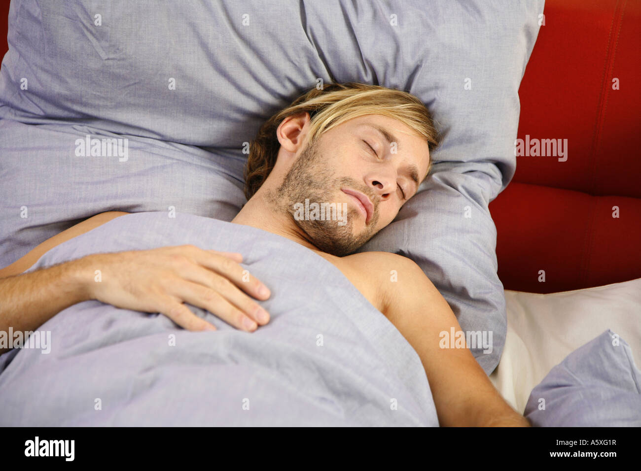 Young man sleeping high angle view Stock Photo - Alamy