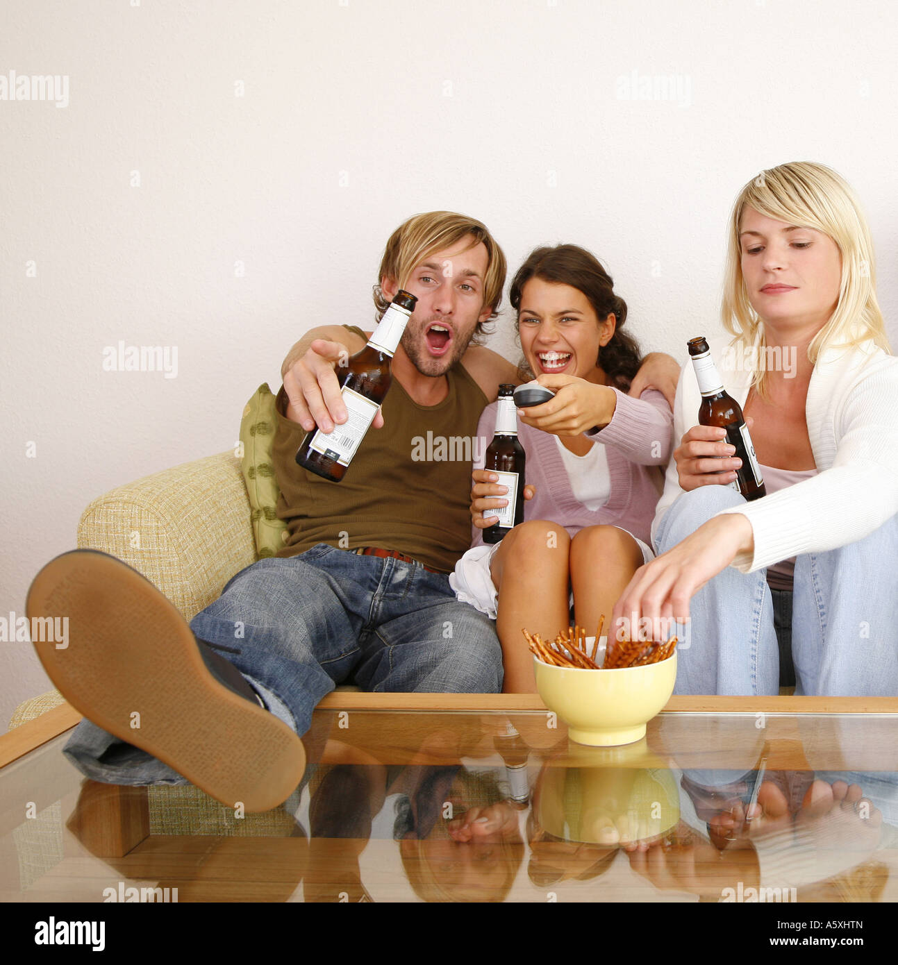 Couple drinking beer on sofa hi-res stock photography and images - Alamy