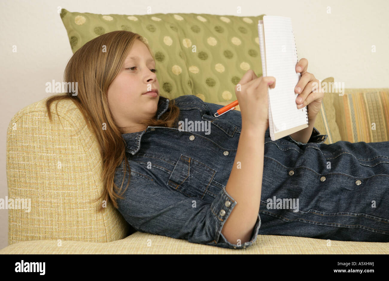Girl 12 13 writing in notebook hi-res stock photography and images - Alamy