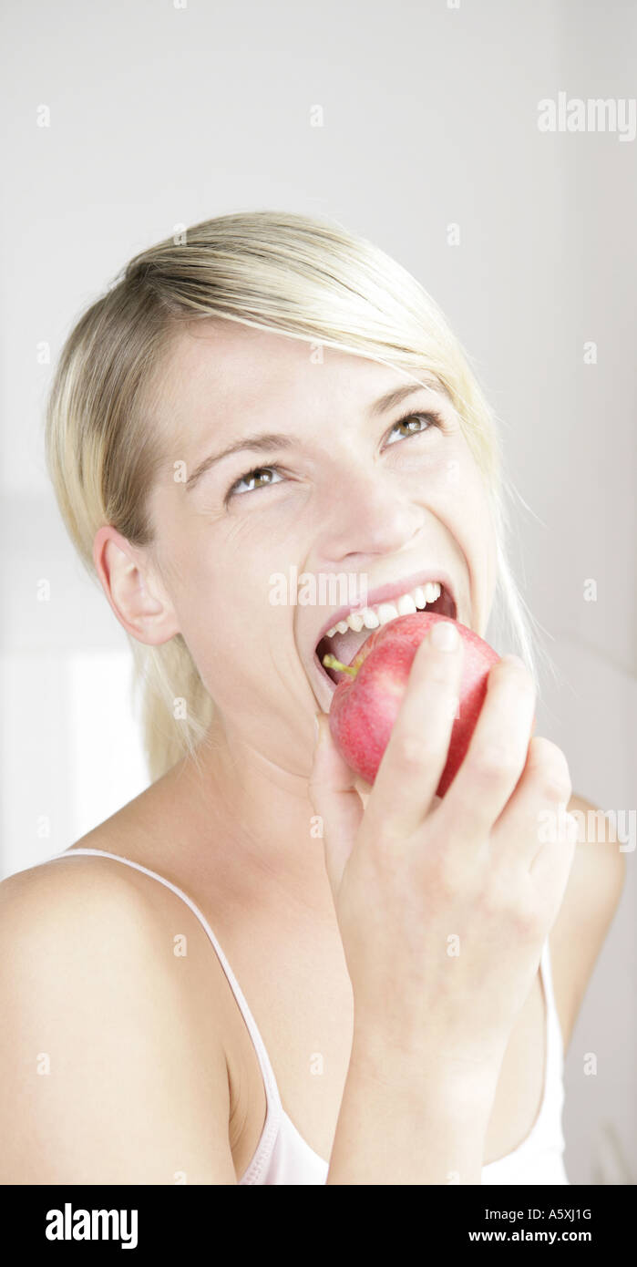 Young woman eating apple portrait close up Stock Photo - Alamy
