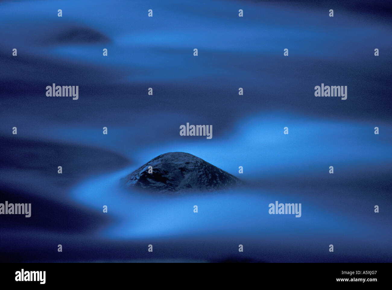 Rock in Blurred Running Water Stock Photo - Alamy