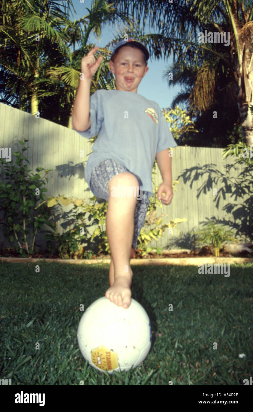 A YOUNG BOY PLAYING SOCCER IN THE BACKYARD BAPS 223 Stock Photo - Alamy