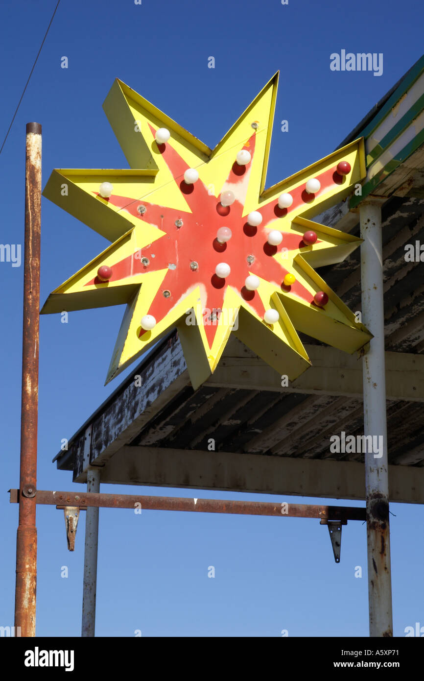 roadside star shaped sign on abandoned store front Stock Photo - Alamy