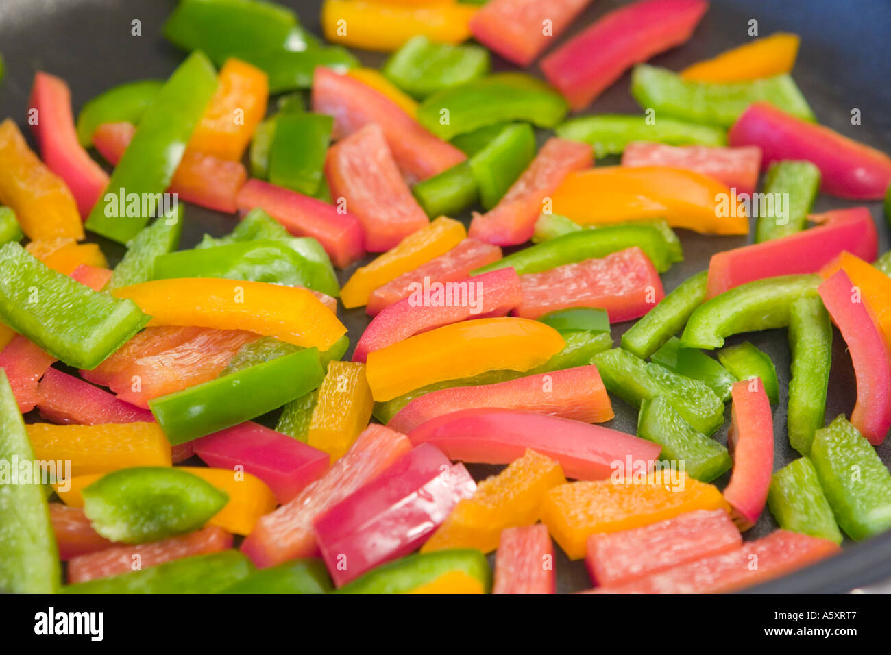 bell peppers cook in a frying pan Stock Photo - Alamy