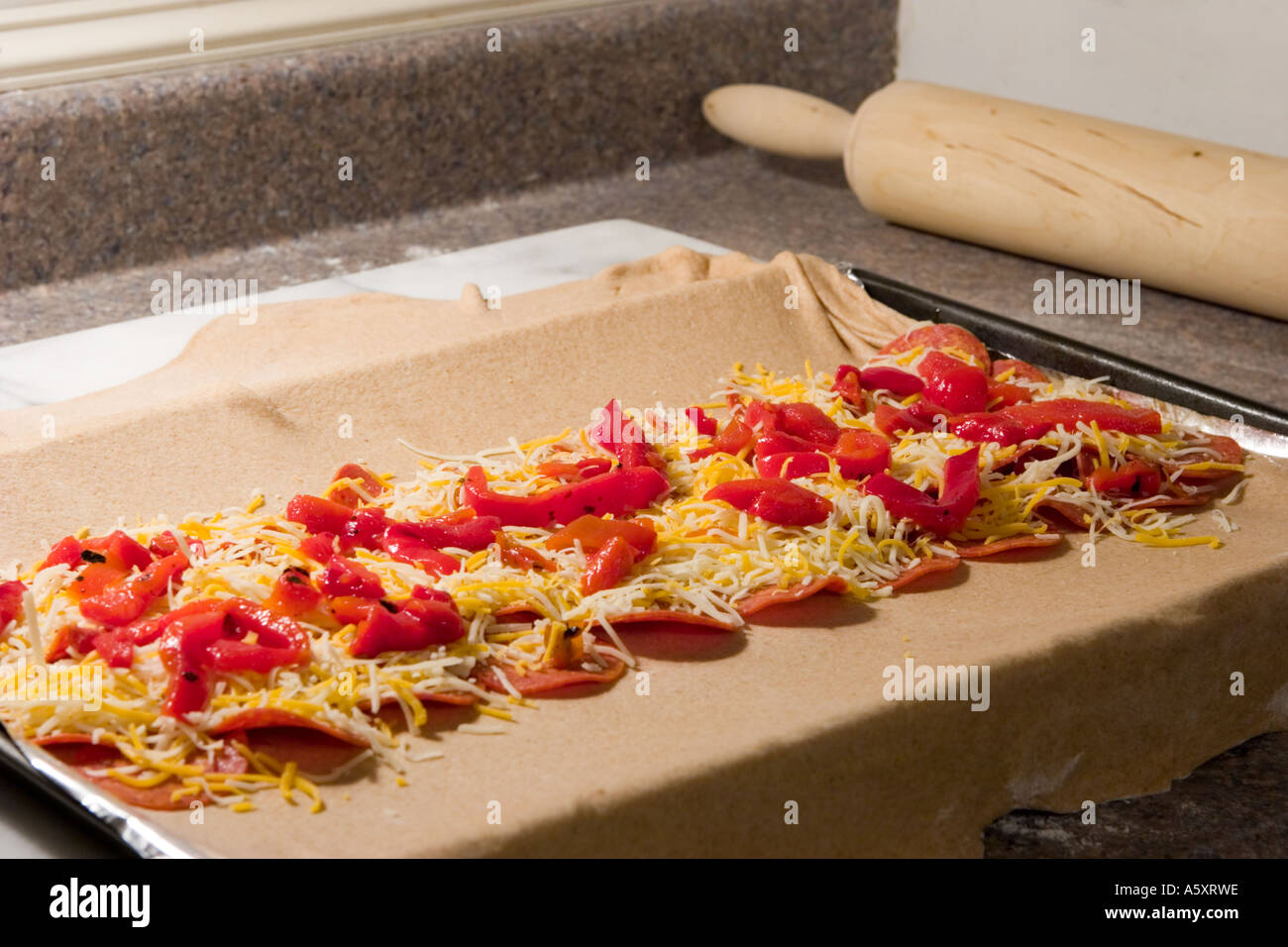 Preparation of pepperoni, pepper & cheese calzone Stock Photo - Alamy