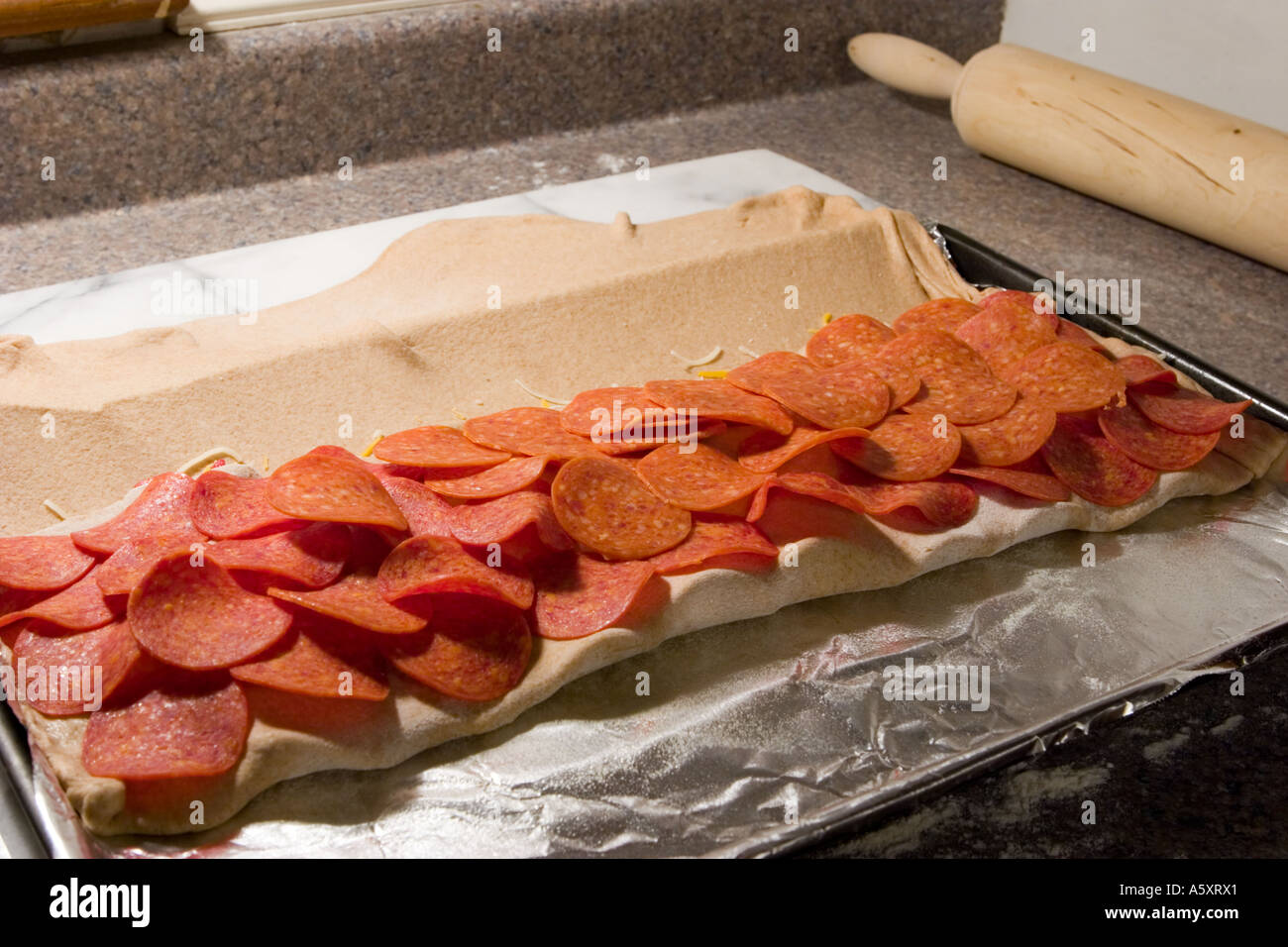 Pepperoni calzone preparation Stock Photo - Alamy